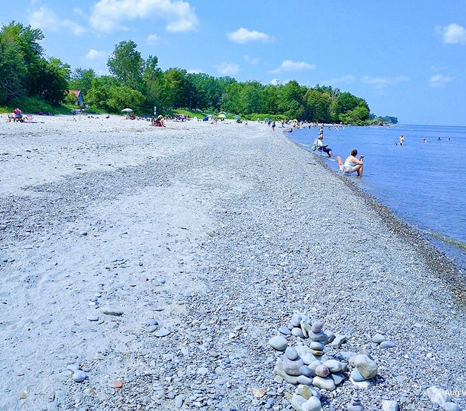 Lake Erie's shoreline—where smooth stones tell geological stories and children build memory castles that wash away with the tide.