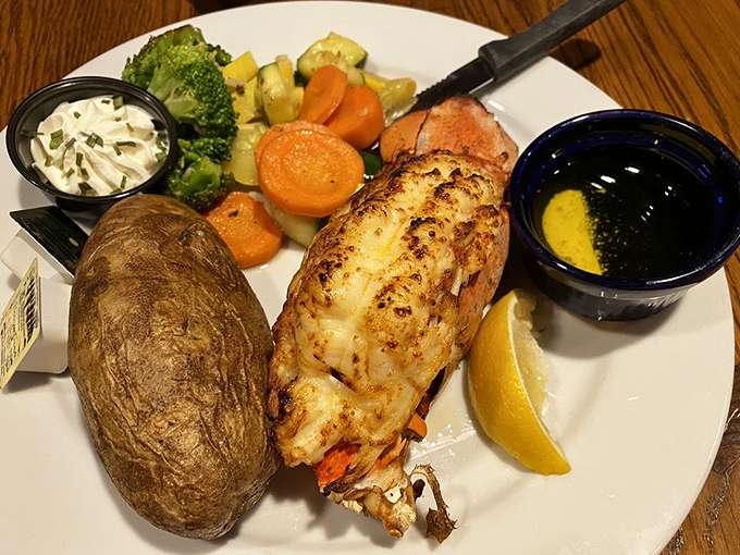 A perfectly broiled lobster tail escorted by seasonal vegetables and a baked potato—the seafood equivalent of rolling out the red carpet.