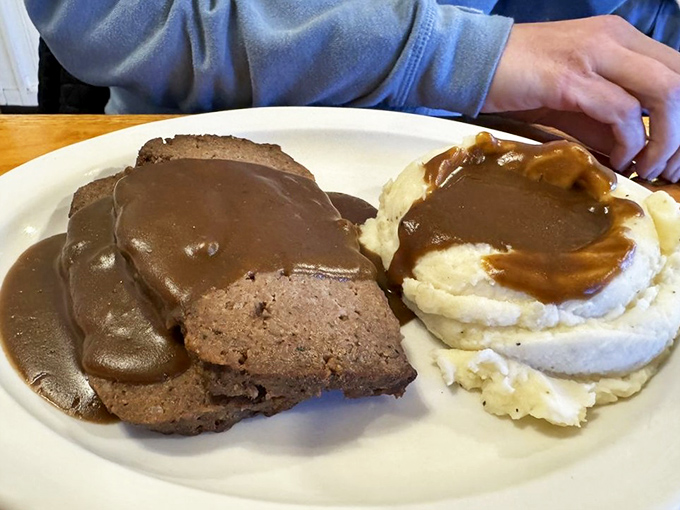 Meatloaf and mashed potatoes swimming in gravy—the kind of plate that makes you want to call your boss and take the afternoon off for a necessary nap.