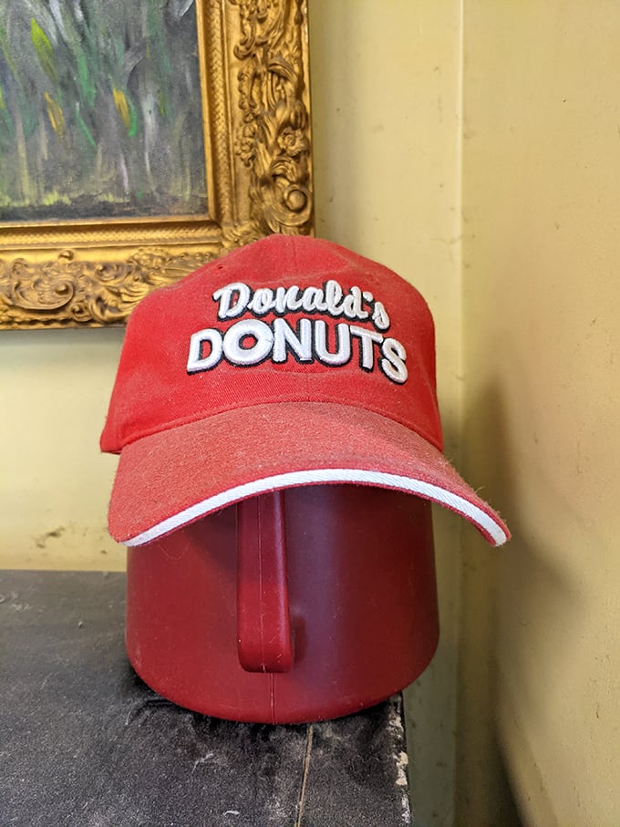 The red Donald's Donuts cap—the unofficial uniform of Zanesville's most devoted fried dough enthusiasts since Kennedy was president.