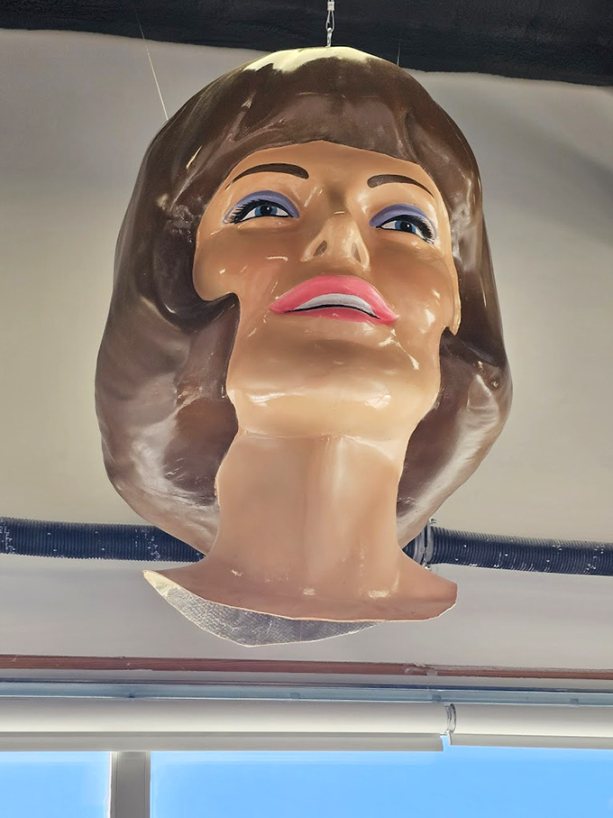 Miss Uniroyal's perfectly coiffed hair and painted smile represent the feminine side of roadside giants—her bell-shaped skirt originally designed to display tires.