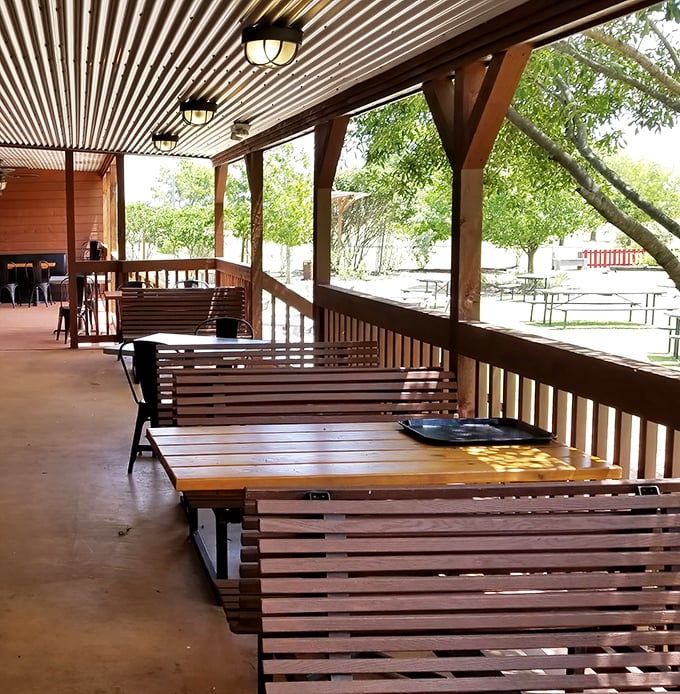 The spacious porch with wooden bench seating invites lingering conversations over cold beers and hot plates as Texas breezes drift through.