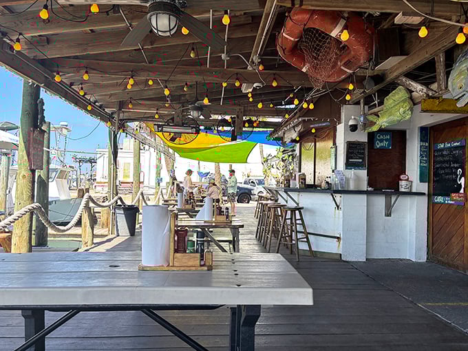 Dining under colorful sails with fishing boats in view—it's not ambiance, it's authenticity. No interior decorator could replicate this vibe.
