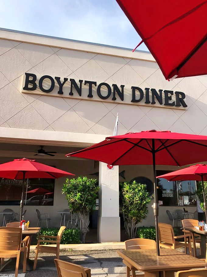 Red umbrellas offering shade for outdoor diners. Florida's version of al fresco dining—where breakfast meets sunshine.