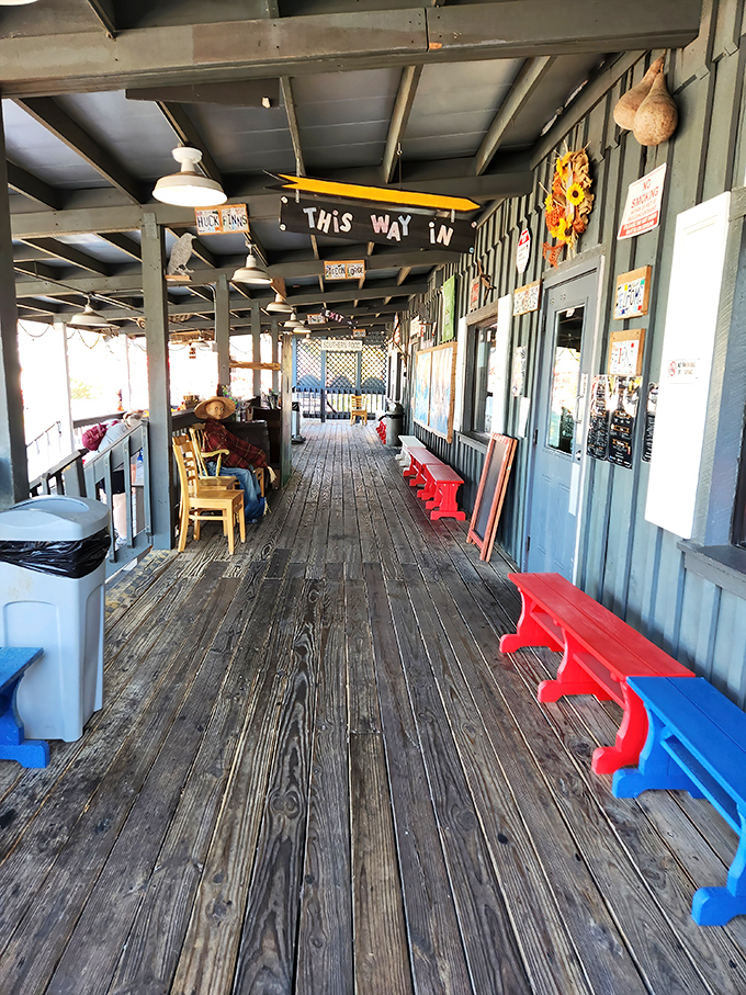 The wooden porch waiting area, with its weathered planks and colorful benches, sets the tone before you even enter. Good things come to those who wait.