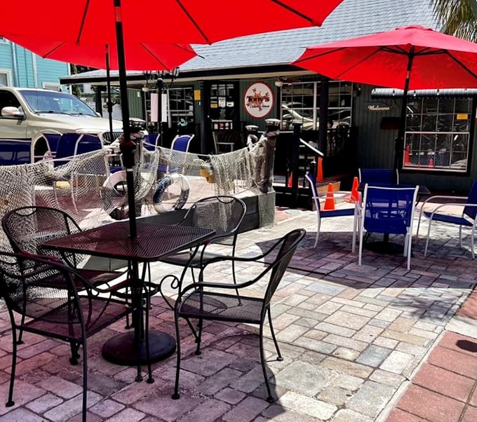 The outdoor patio offers fresh air with your fresh seafood – a perfect Florida dining equation under cheerful red umbrellas.