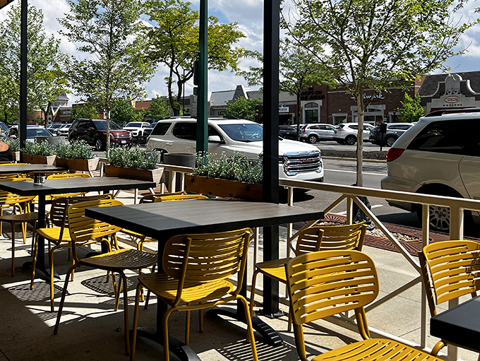 Yellow chairs on the patio practically shouting "Sunshine!" even on cloudy days—proof that outdoor dining is a state of mind.