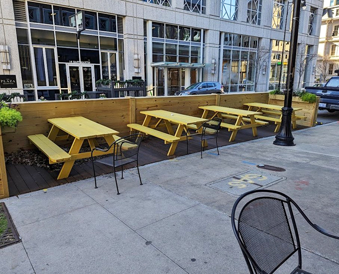 The outdoor seating area doesn't just offer fresh air—it provides front-row seats to downtown Raleigh's daily parade of humanity. 