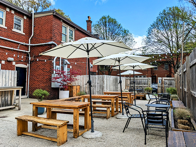 Al fresco dining done right—rustic wooden tables under market umbrellas create an urban oasis for your breakfast sandwich rendezvous.