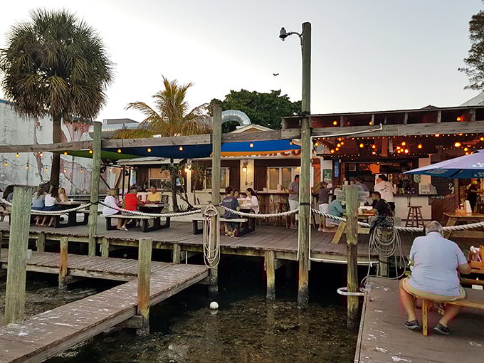 As evening falls, the deck transforms into a twinkling oasis where conversations flow as freely as the nearby waters. 