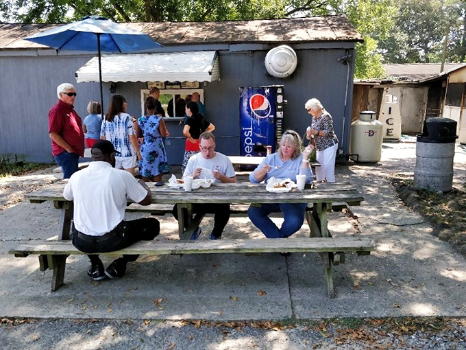 Al fresco dining, B's style. Picnic tables under shade trees—nature's dining room for barbecue enthusiasts who can't wait to dig in.