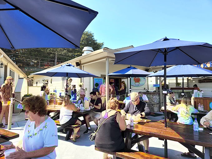 Picnic tables under blue umbrellas—because seafood this fresh deserves to be enjoyed with a soundtrack of seagulls and ocean breezes.