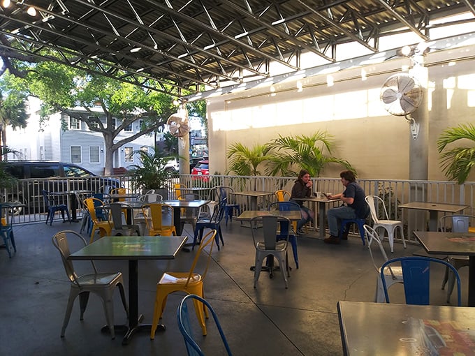 The outdoor seating area offers a shaded escape with colorful chairs—perfect for enjoying your burger while people-watching in downtown Melbourne.