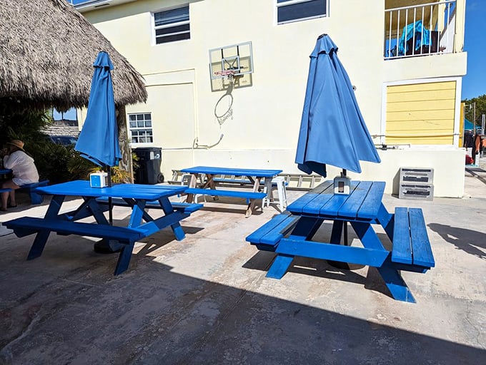 Blue picnic tables under Florida skies—where memories are made between bites of perfectly prepared seafood.