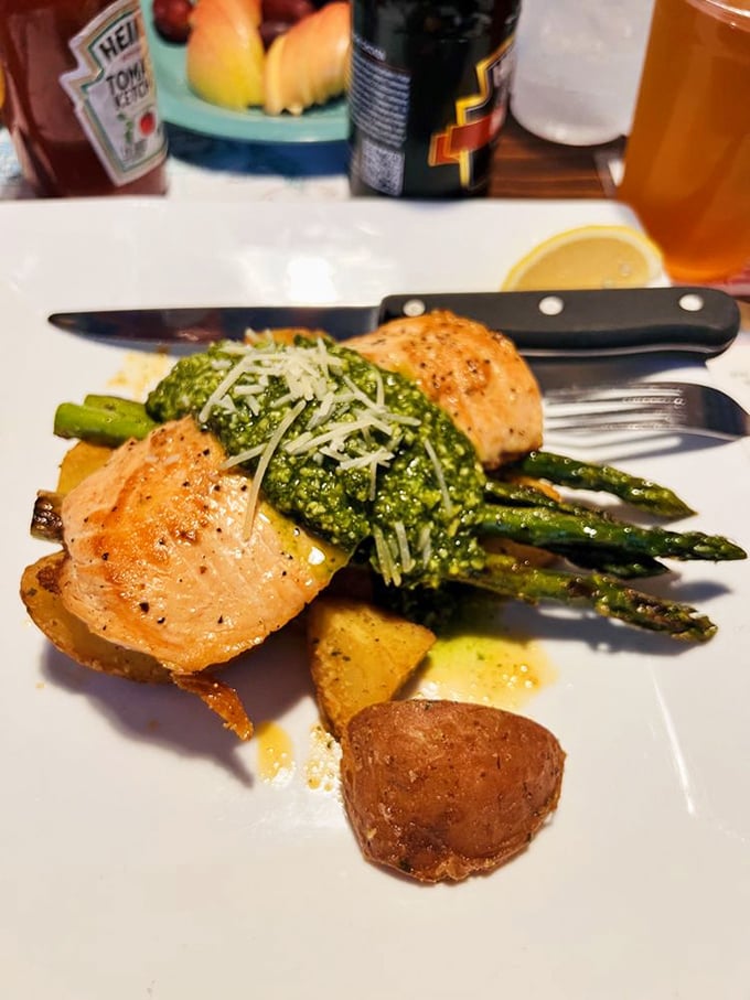 Salmon that didn't just get seared—it got pampered. Resting on a bed of pesto with asparagus spears standing at attention like tasty green soldiers.