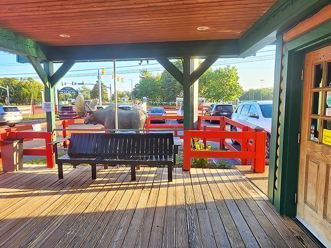 The waiting area features a bench and – is that a rhino? Proof that at Caney Fork, even waiting for your table is an unexpected adventure.