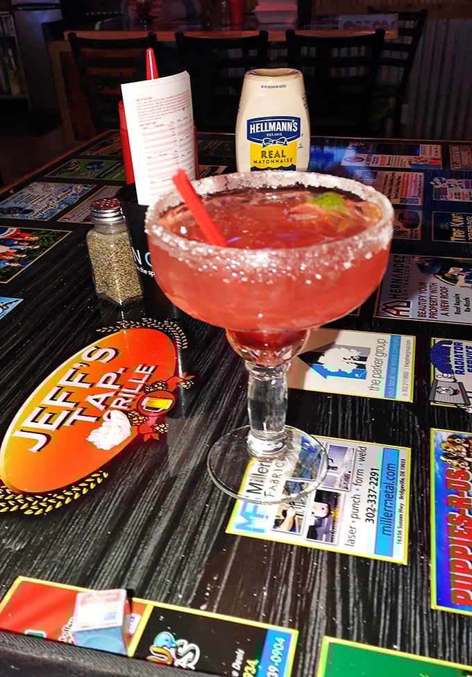 That salt-rimmed margarita isn't just a drink—it's a vacation in a glass. Table decor suggests you're in a taproom, but your taste buds are on a beach.