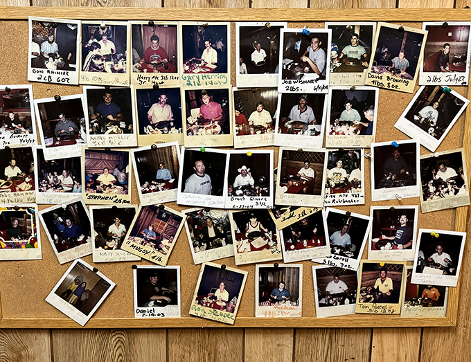 Each Polaroid tells a story of conquest—a wall of fame documenting brave souls who've tackled the 32-ounce Cowboy Porterhouse and lived to tell the tale.
