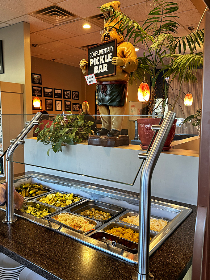 The complimentary pickle bar—a shrine to fermentation that deserves your respect and frequent visits. That chef statue stands guard over treasures both briny and sweet.