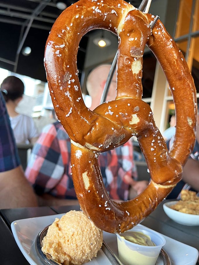 That towering pretzel isn't just a snack – it's a golden monument to the art of perfect bar food.