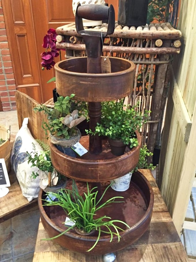 This three-tiered wooden display piece isn't just country chic—it's practically begging to become the conversation starter on your patio.