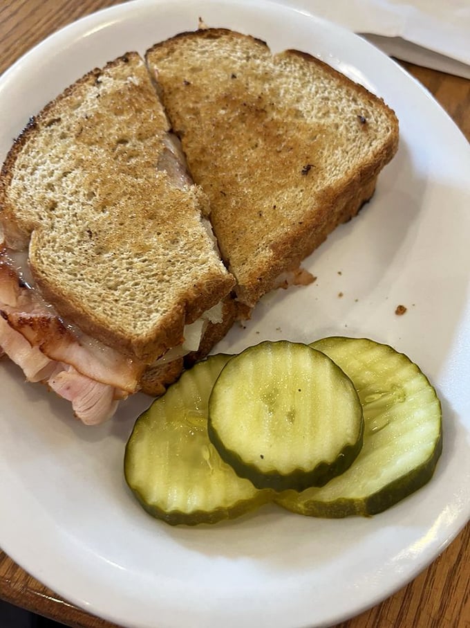 A proper Reuben doesn't need fancy presentation. Just quality ingredients, proper grilling, and those perfect pickle slices on the side.