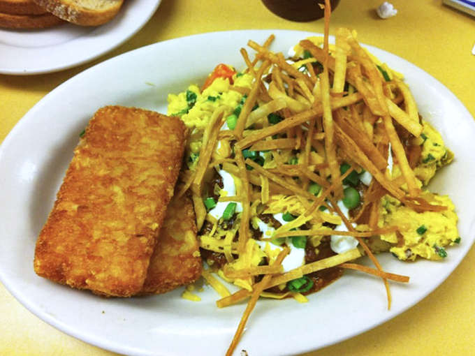 This scramble doesn't just sit there—it performs, with crispy potatoes playing backup to eggs that clearly graduated from culinary school.