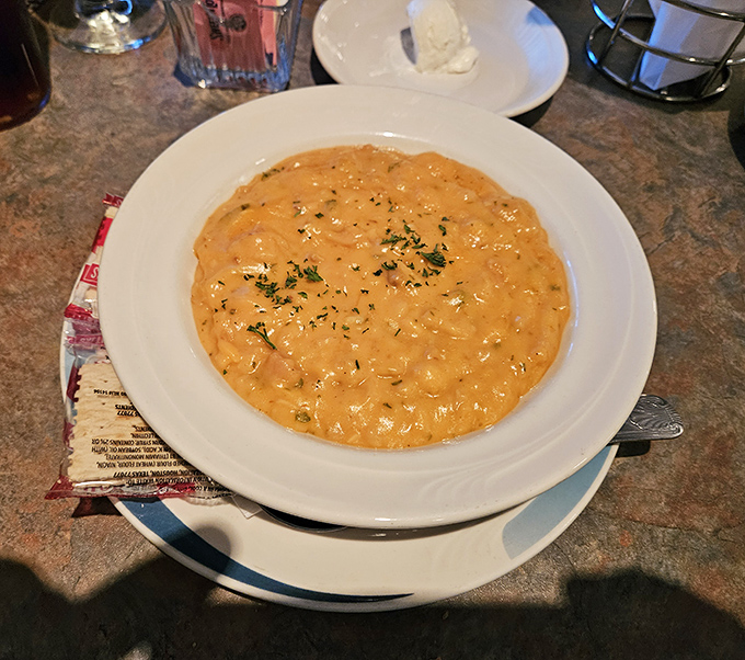 This creamy seafood bisque doesn't just sit in the bowl—it beckons, promising spoonfuls of oceanic comfort in every bite.