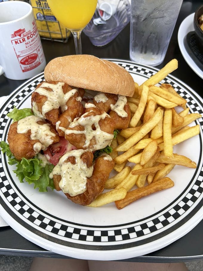 The seafood sandwich that launched a thousand road trips. Crispy fried shrimp nestled in a soft bun with remoulade sauce – Neptune himself would approve.