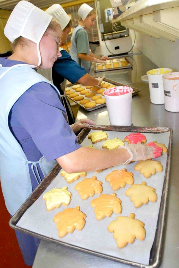 Hands that create happiness, one maple leaf cookie at a time. These bakers aren't just workers—they're artisans continuing centuries of tradition.