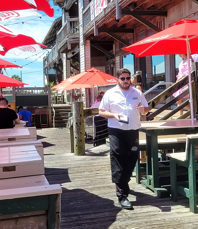 Service with Southern efficiency—staff navigate the bustling deck with the confidence of sailors who know these wooden boards like the back of their hands.