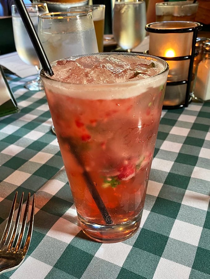 A strawberry mojito that looks like summer in a glass, ready to convince you that fruit counts as a serving of vegetables.