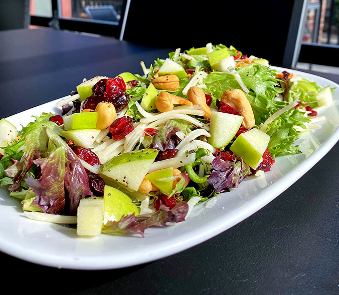 This isn't prison cafeteria fare—crisp greens, apple slices, and dried cranberries create a salad that would start a riot in Cell Block D.