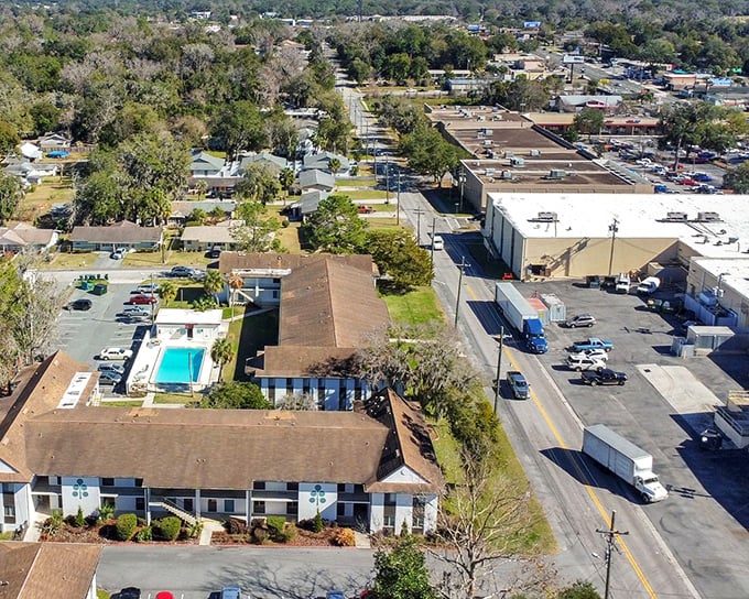 This aerial view of apartment living shows why retirees flock to Ocala—affordable housing arranged around water features that rival resort amenities.