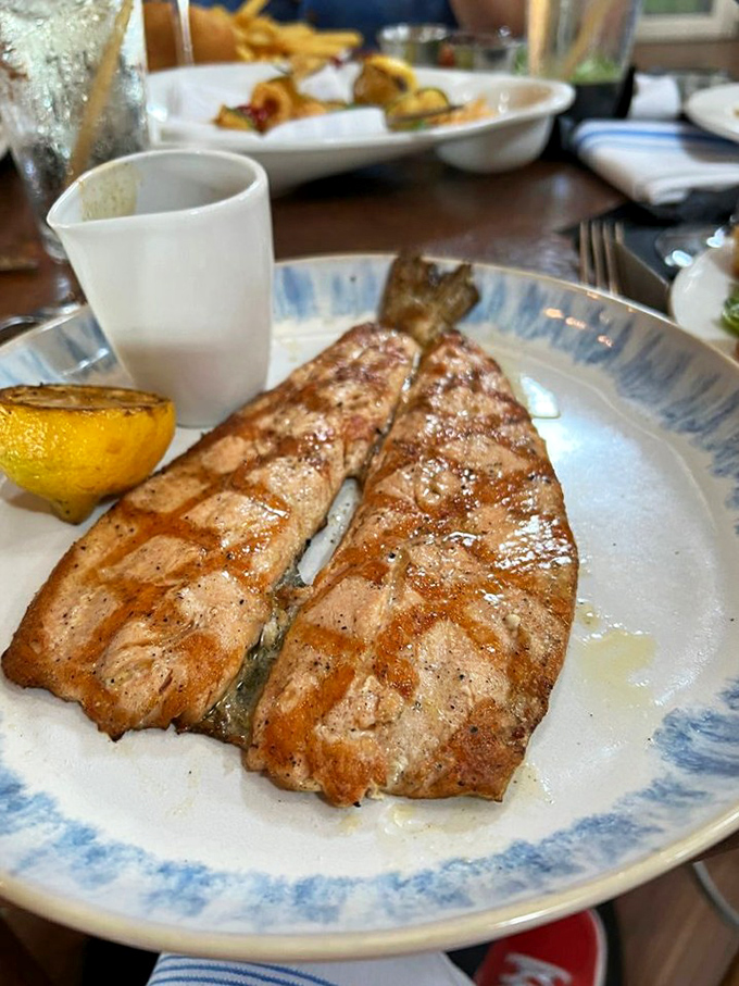 This isn't just grilled fish—it's a masterclass in simplicity. Those perfect grill marks are the culinary equivalent of a chef's signature.