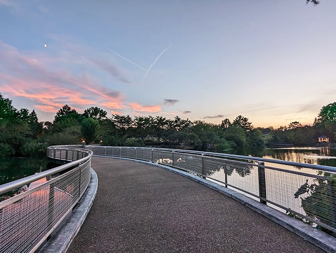 As twilight descends, the garden's curved walkway becomes a journey between two worlds—daytime reality and evening enchantment.