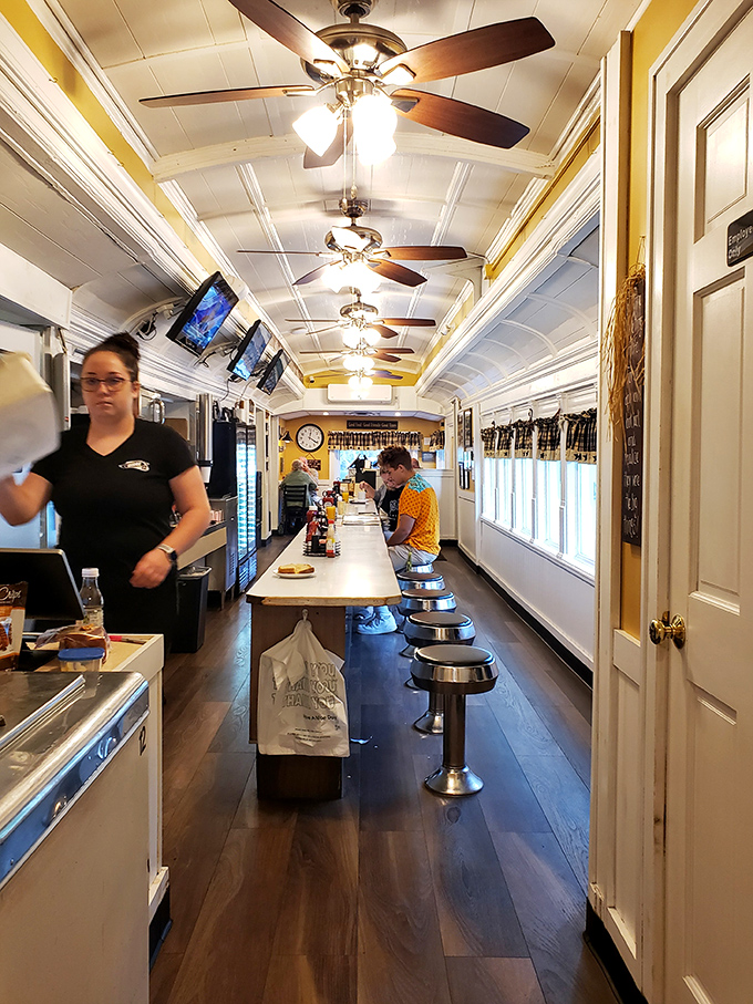 The counter view – where regulars perch like birds on a wire, watching the breakfast ballet unfold. Ceiling fans keep the gossip circulating.