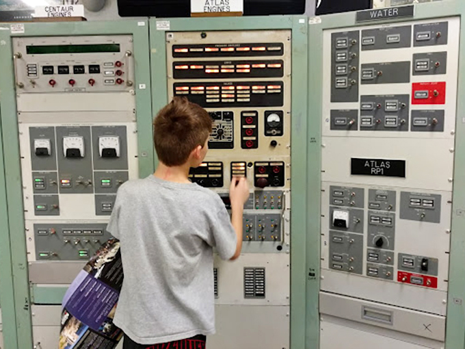 Future mission specialist at work! This young visitor discovers that buttons and switches from decades ago still have the power to ignite imagination.