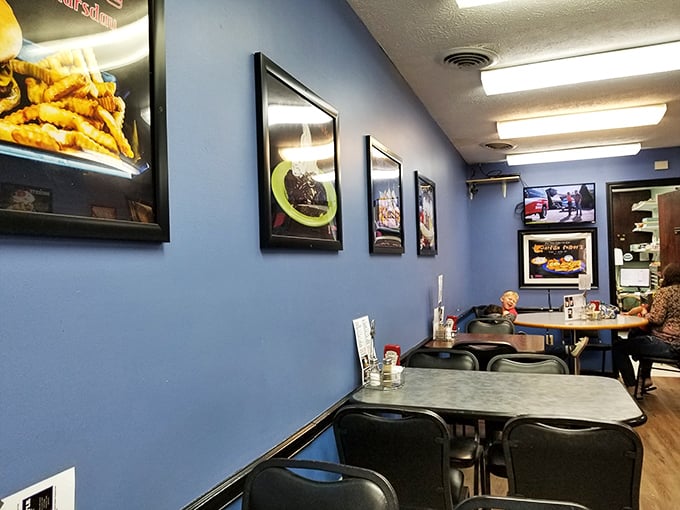 Food photos line the blue walls like a gallery of edible art. More honest than any museum—you can actually have what you see.