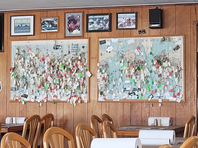 The wall of business cards and notes isn't decoration—it's a physical Yelp review from the days before smartphones.