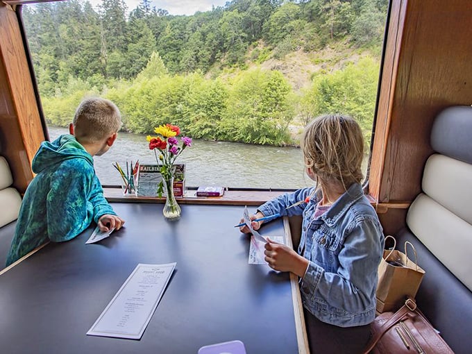 Two young artists capture the rushing river and emerald landscape—proof that Oregon's beauty inspires creativity in travelers of all ages.