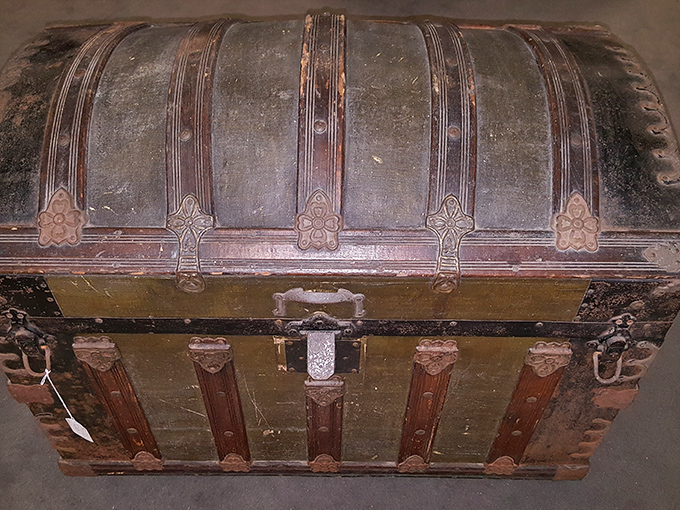 A genuine steamer trunk that's traveled more miles than most modern suitcases – adventure incarnate in leather and brass.