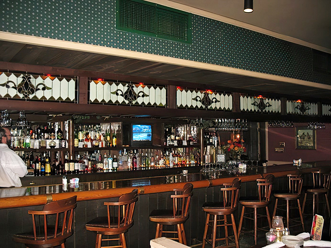 A bar stocked for serious business. Those stained glass accents aren't just pretty—they're filtering light to make everyone look mysteriously attractive.