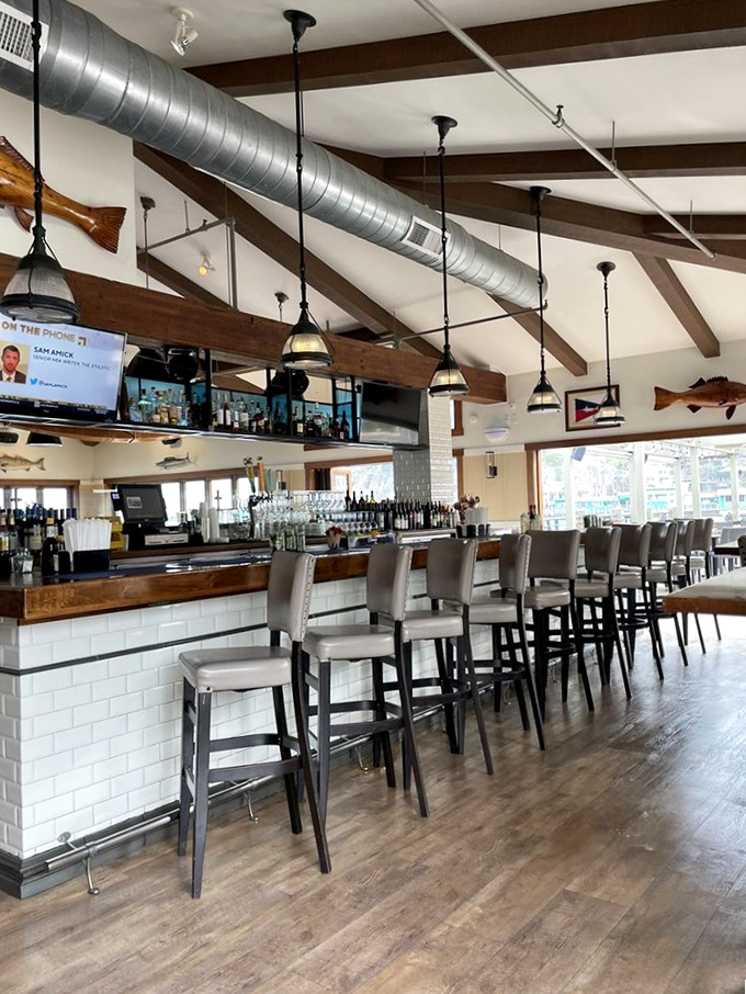 The bar at Bluewater isn't just where drinks are made—it's where island stories are exchanged under the watchful gaze of mounted fish.