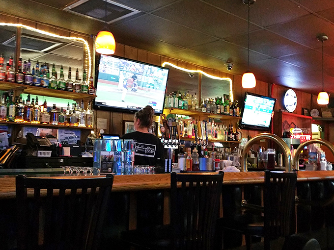 The bar area—where strangers become friends and friends become family. Sports on TV, spirits on shelves, and stories waiting to be shared.