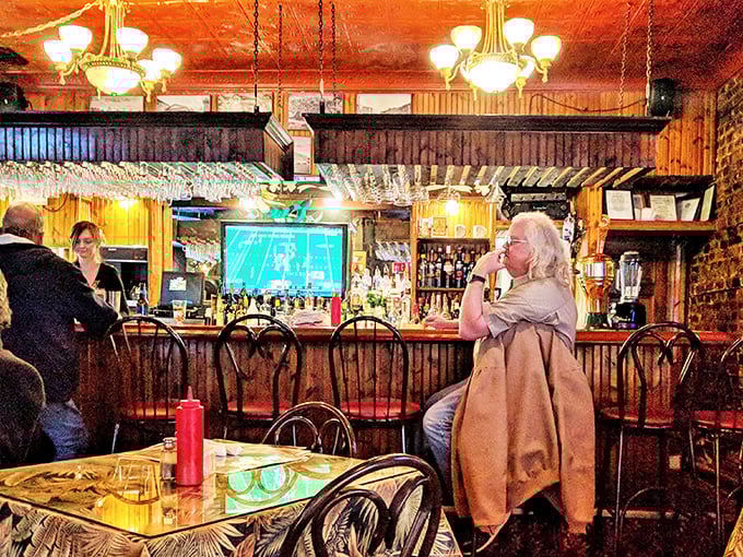 The bar area—where strangers become friends and regulars are treated like royalty. That warm wooden glow makes every beer taste better and every story more interesting.