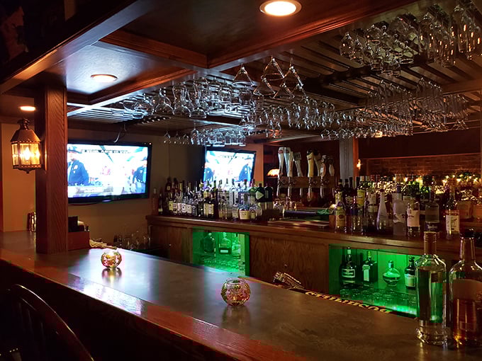 The bar isn't just well-stocked—it's a liquid library of possibilities with glasses hanging like crystal stalactites from the ceiling.