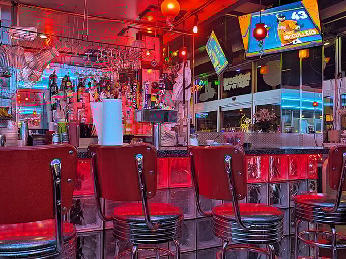 The counter seating bathes in a red glow that makes everyone look like they're plotting their next meal in a 1950s sci-fi film.