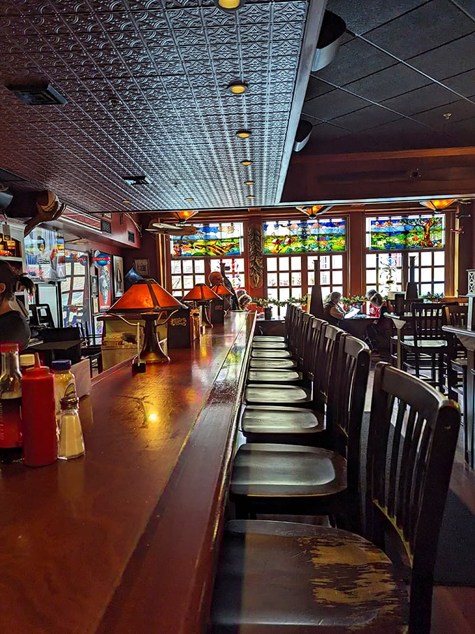 Where burger dreams and stained glass windows collide. The bar at Dotty's isn't just a place to sit—it's front-row seating to a culinary performance.