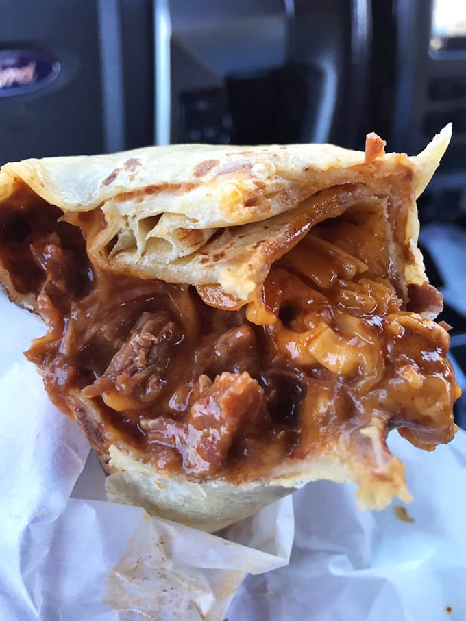 Cross-section of contentment. The beef burrito reveals its secrets—a perfect marriage of meat, beans, and cheese that's worth every napkin.
